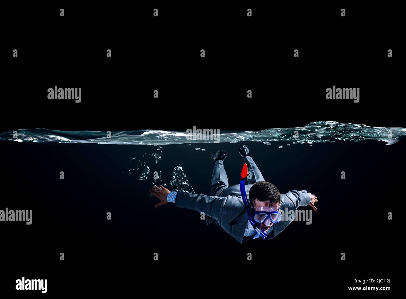 Funny businessman swimming underwater . Mixed media Stock Photo - Alamy
