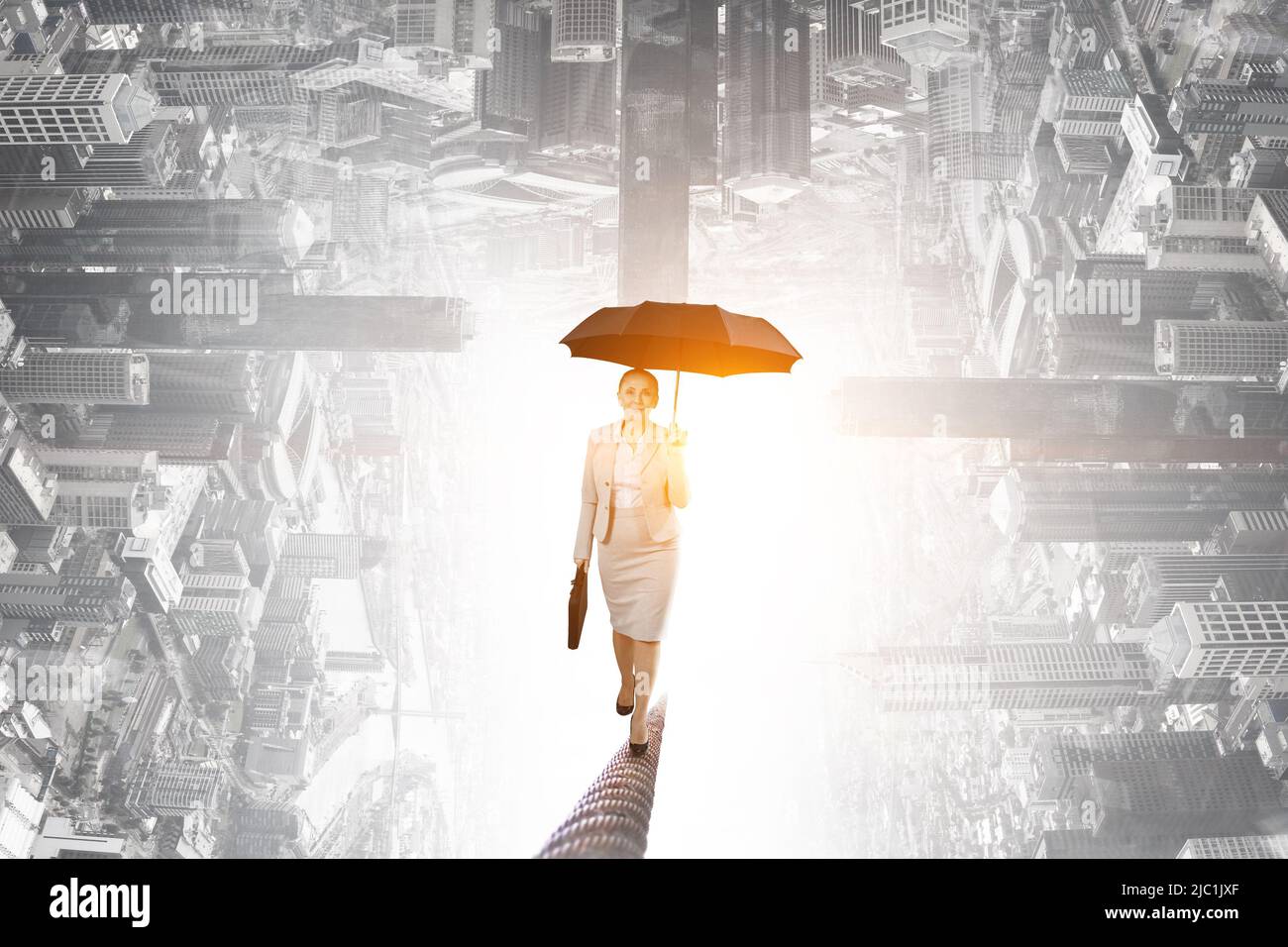 Businesswoman running with umbrella . Mixed media Stock Photo - Alamy