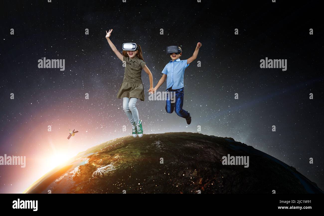 Kids wearing virtual reality goggles Stock Photo - Alamy