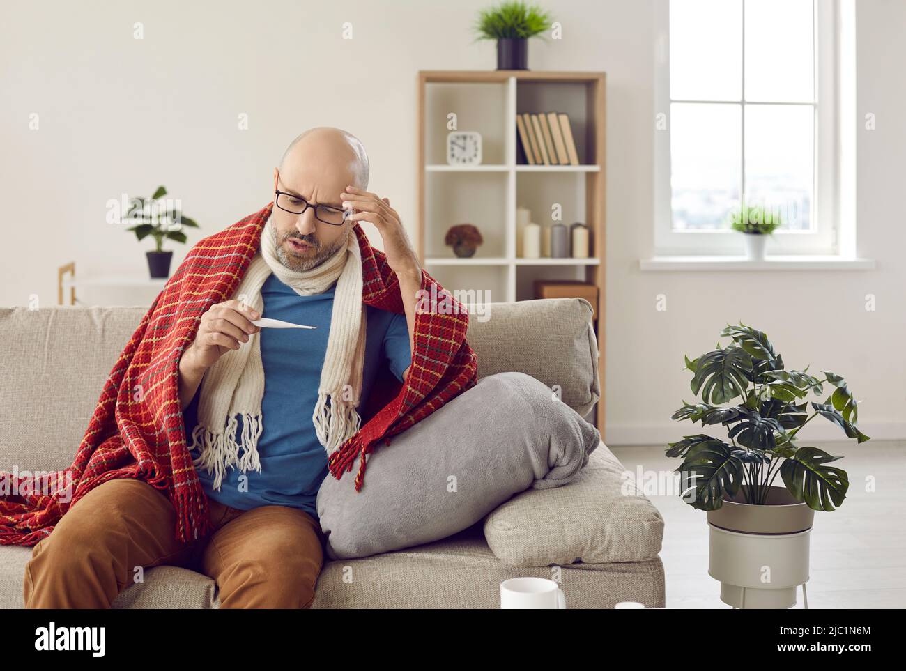 Unhealthy man measure temperature suffer from fever Stock Photo - Alamy