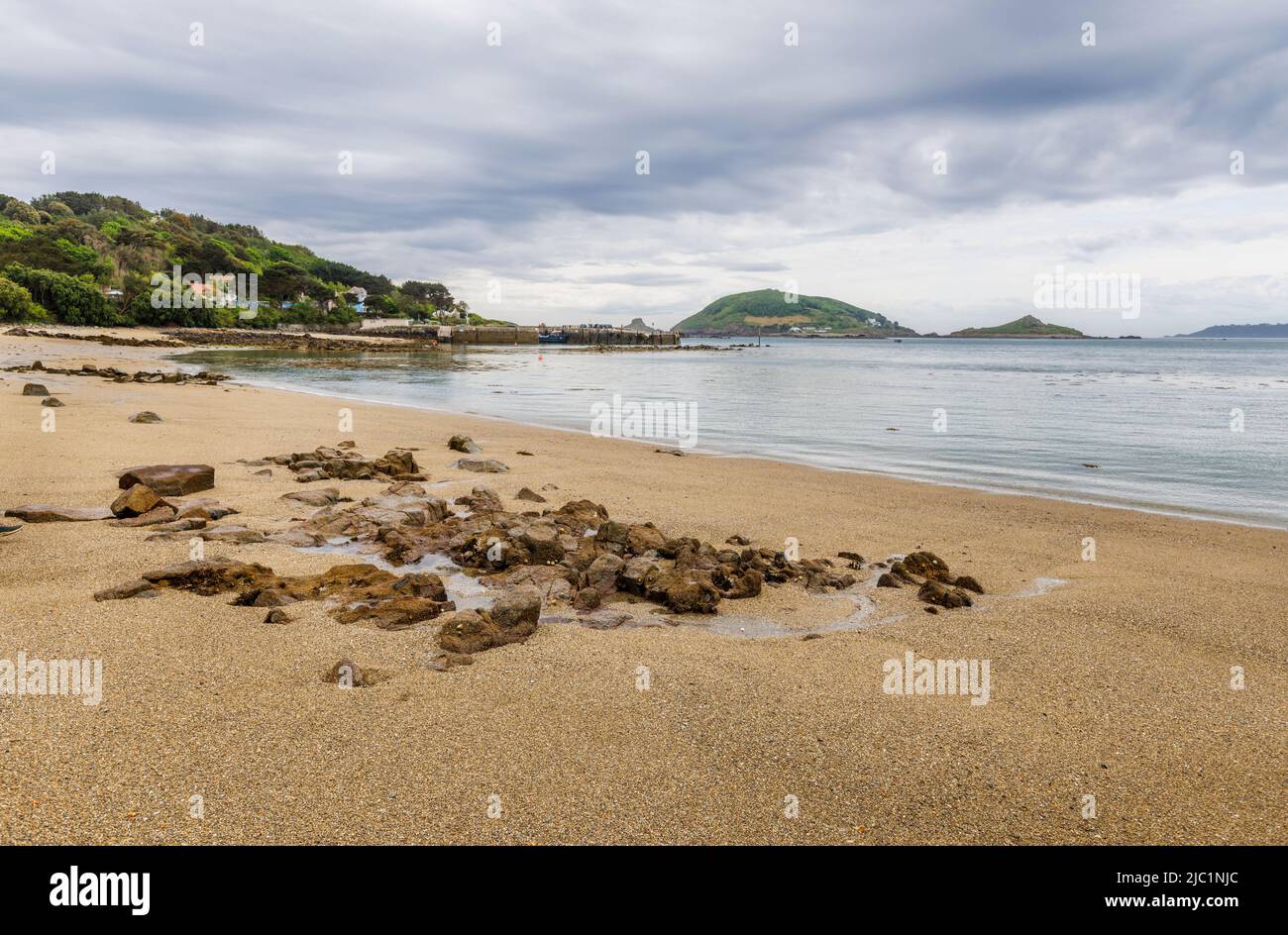 Fisherman's Beach looking towards the Harbour and Jethou island on the ...
