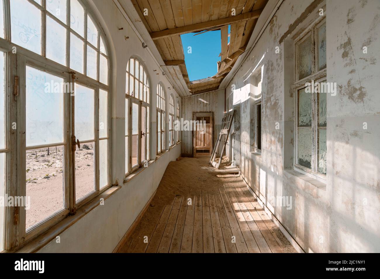 abandoned building terrace full of desert sand in Kolmanskop town in ...