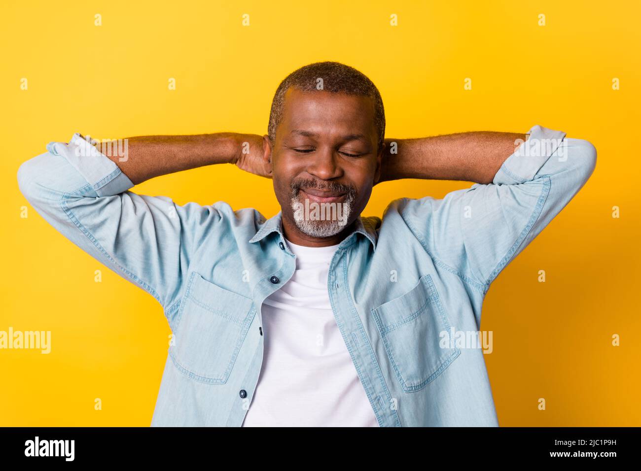 Photo of calm positive man closed eyes hands behind head take nap ...