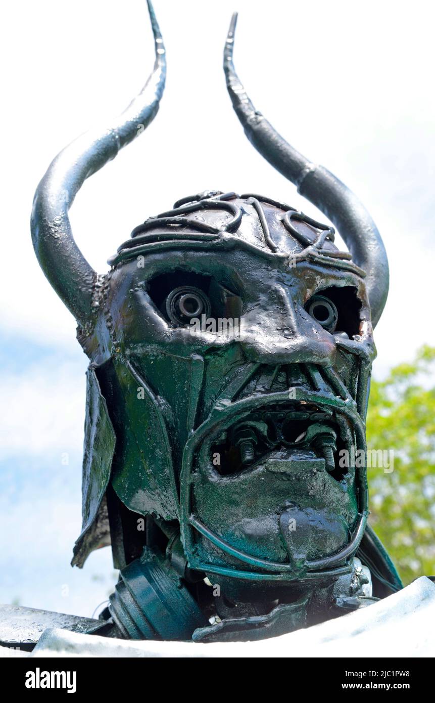 Handmade metal head of Minotaur set in a city park, artistic forging ...