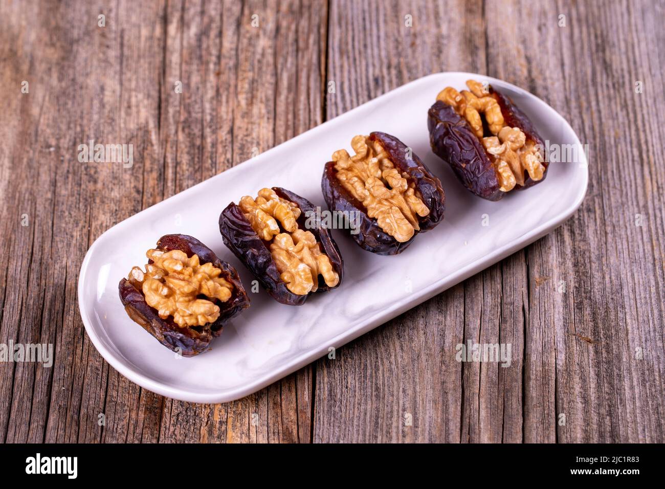 Walnut-stuffed dates on a wood floor. Close-up. Arabian luxury for ...