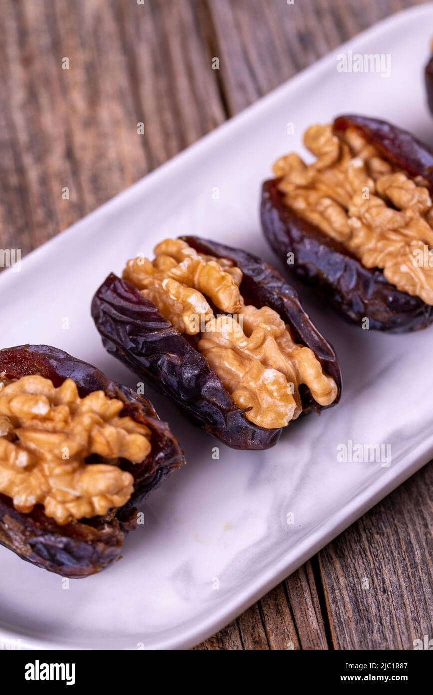 Walnut-stuffed dates on a wood floor. Close-up. Arabian luxury for ...