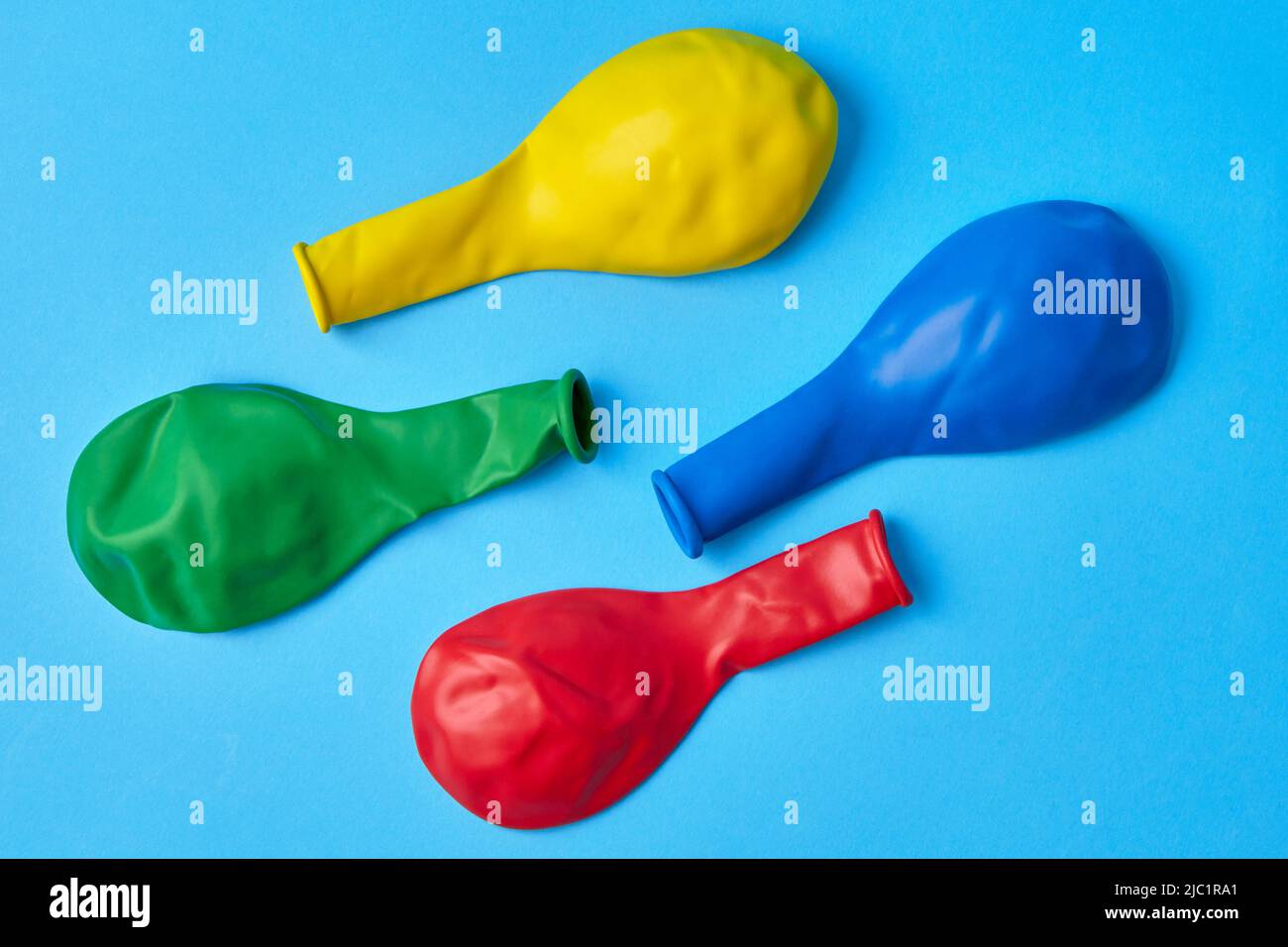 Multi-colored not inflated balloons red, yellow, blue, green lie ...