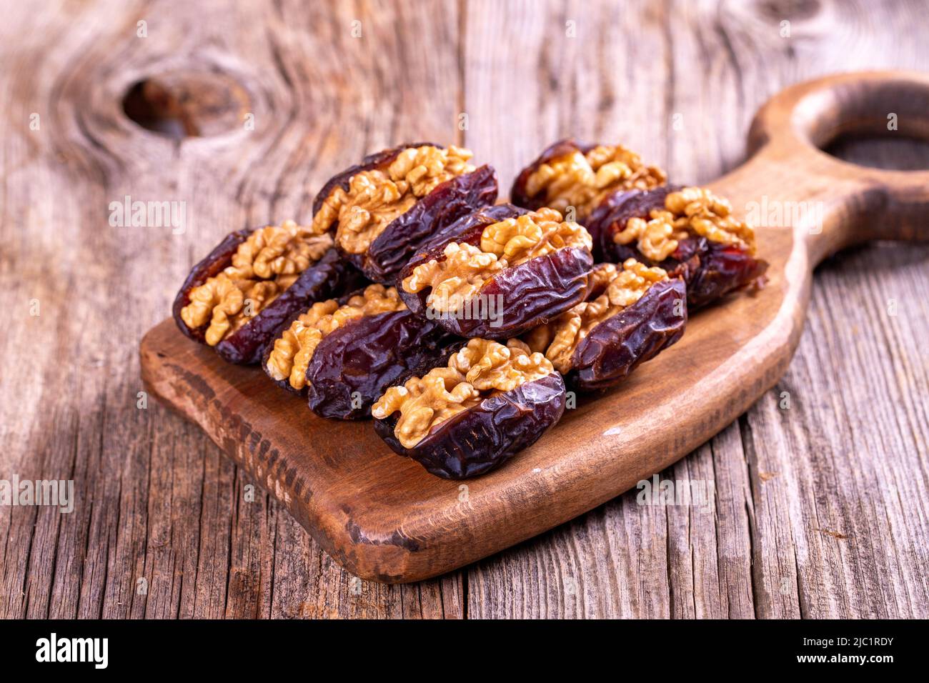 Walnut-stuffed dates on a wood floor. Close-up. Arabian luxury for ...