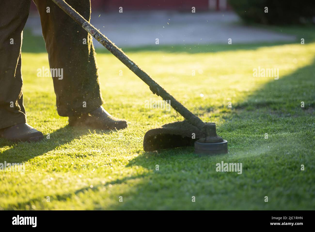 Mowing the grass with a lawn mower. Garden work concept background ...