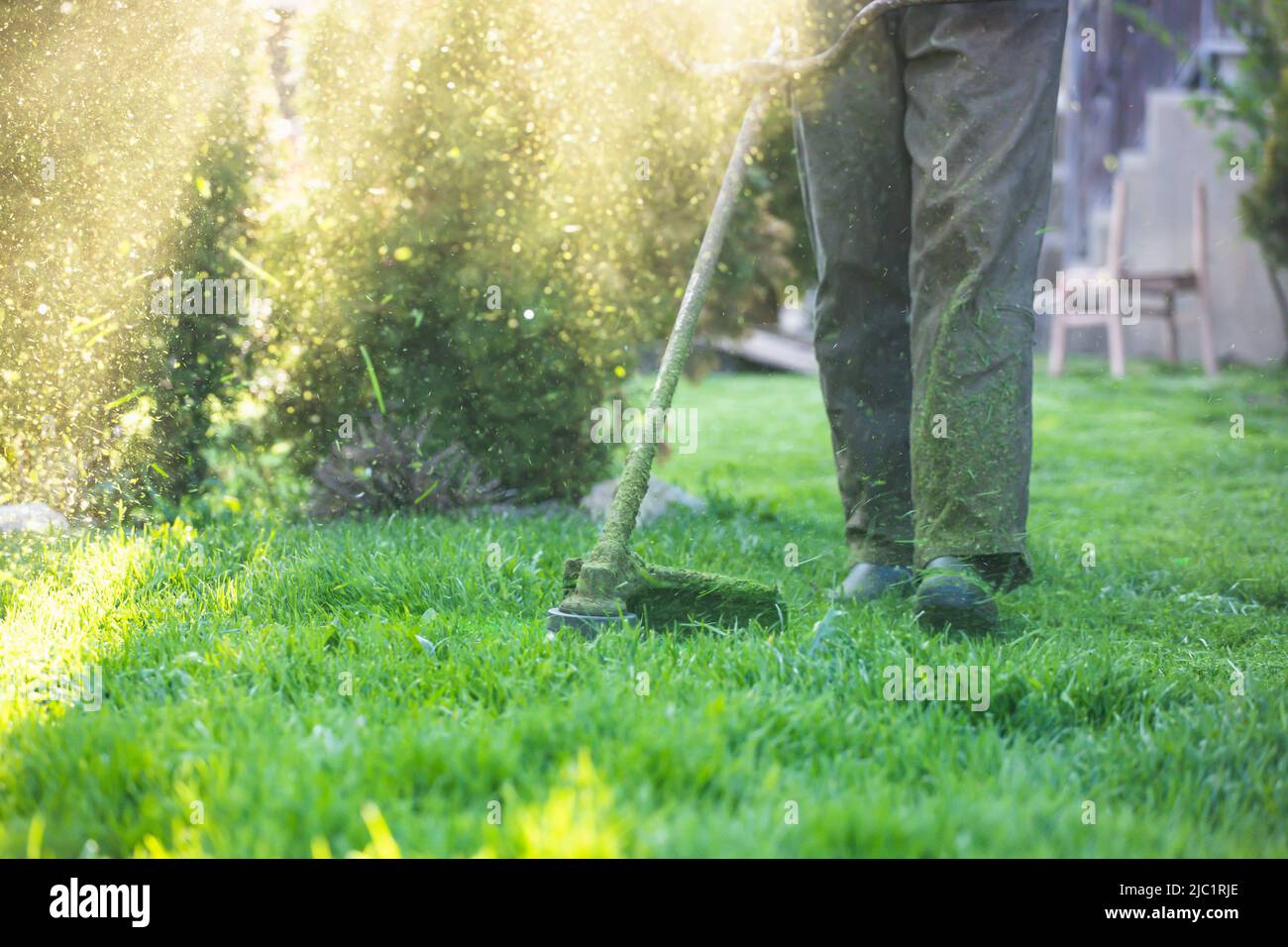 Mowing the grass with a lawn mower. Garden work concept background ...