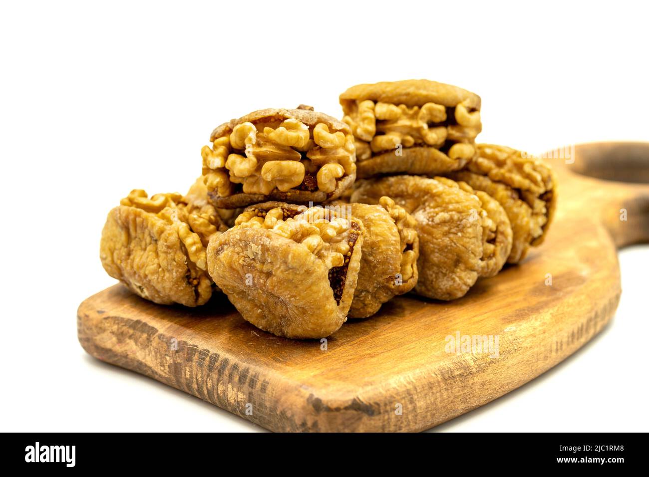 Stuffed dried figs. Dried figs stuffed with walnuts isolated on white ...
