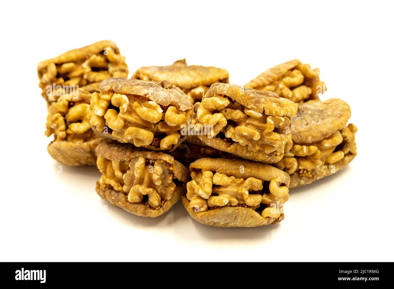 Stuffed dried figs. Dried figs stuffed with walnuts isolated on white ...