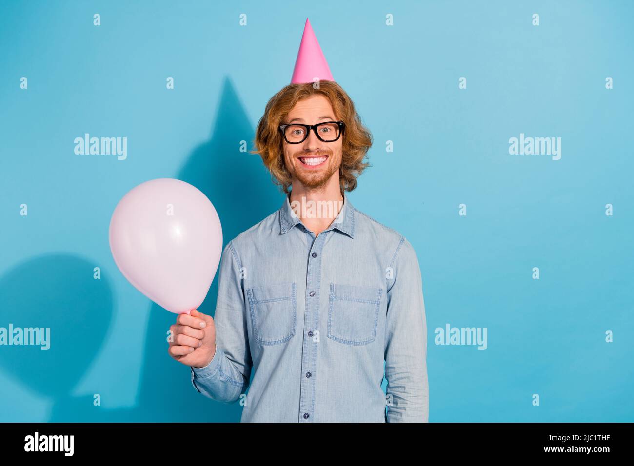 Photo of funky cute young guy dressed jeans shirt eyewear headwear ...
