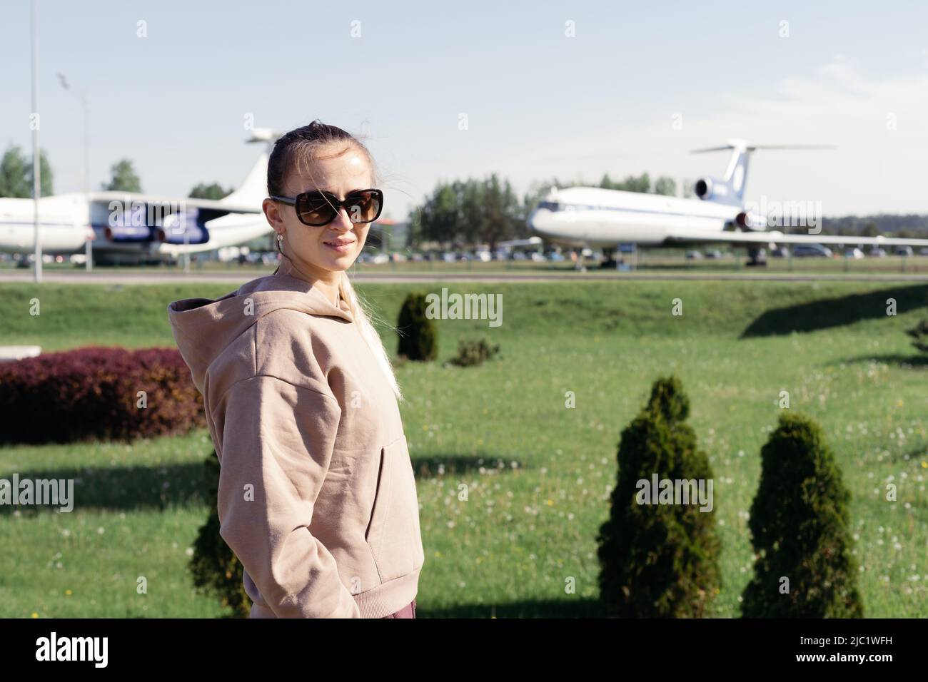 woman standing in an open area at the airport Stock Photo - Alamy