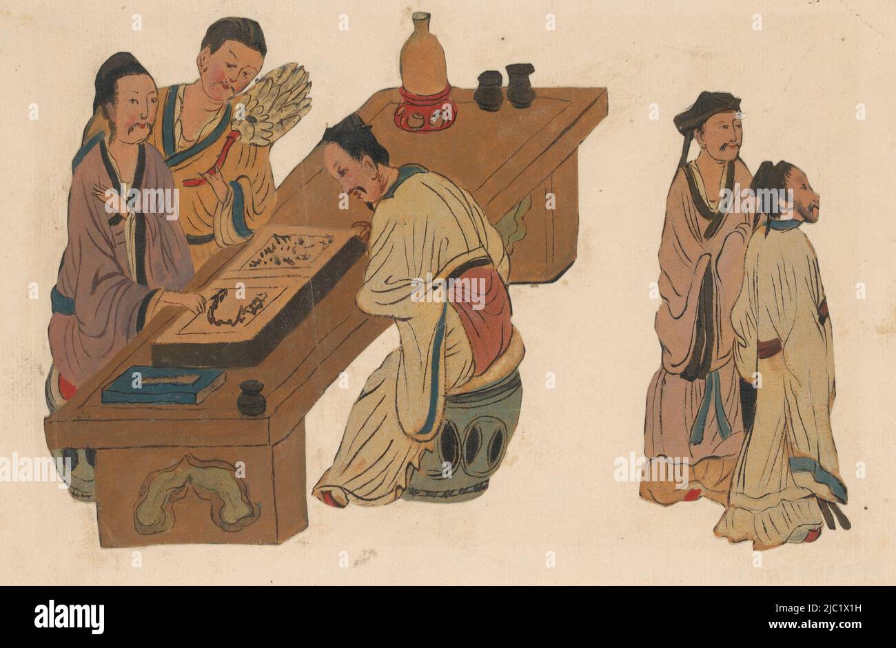 Three men around a table with an open book on it. On the right two men ...