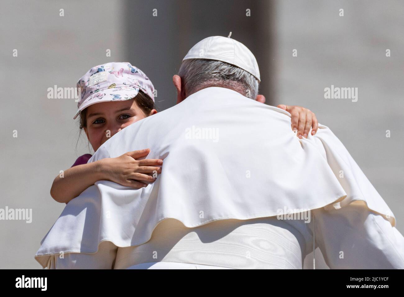 Pope Francis hugs a child as he leaves St. Peter's Square after ...