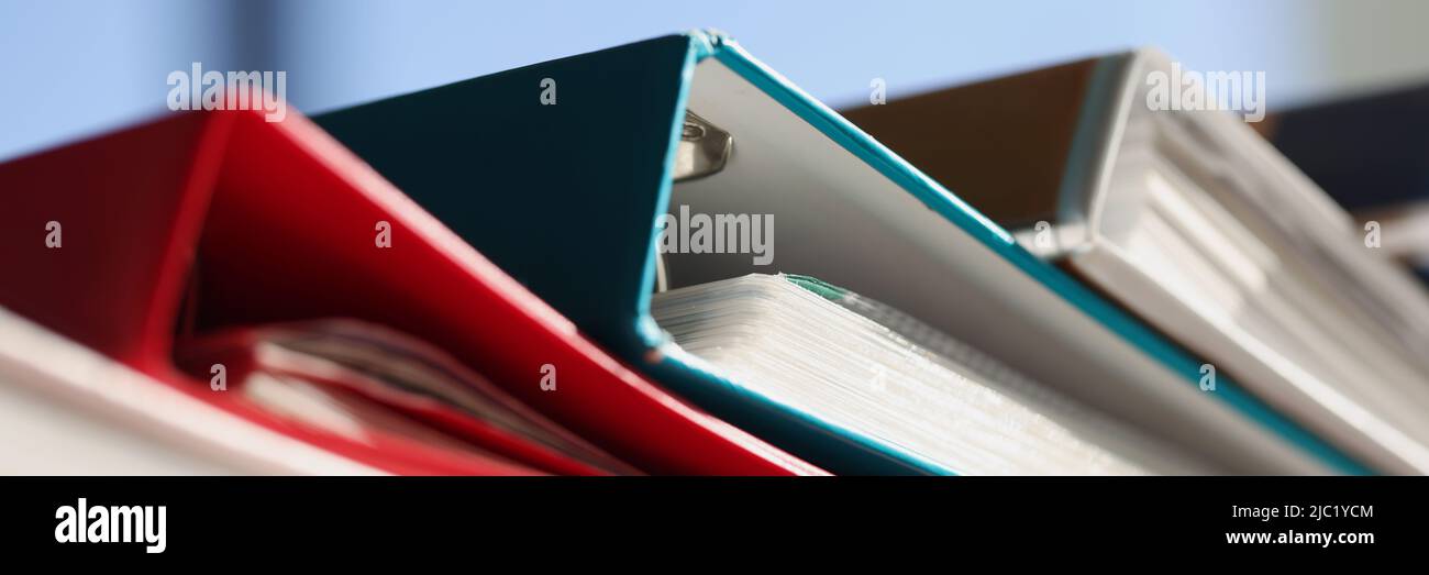 Stack of colourful folders for documents on table Stock Photo - Alamy