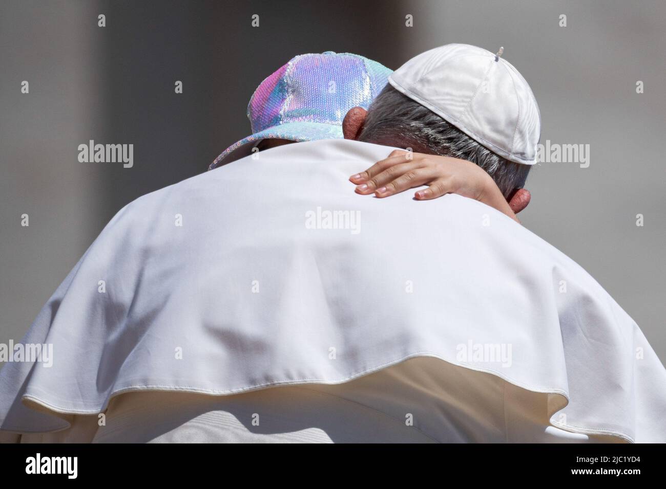 Pope Francis hugs a child as he leaves St. Peter's Square after ...