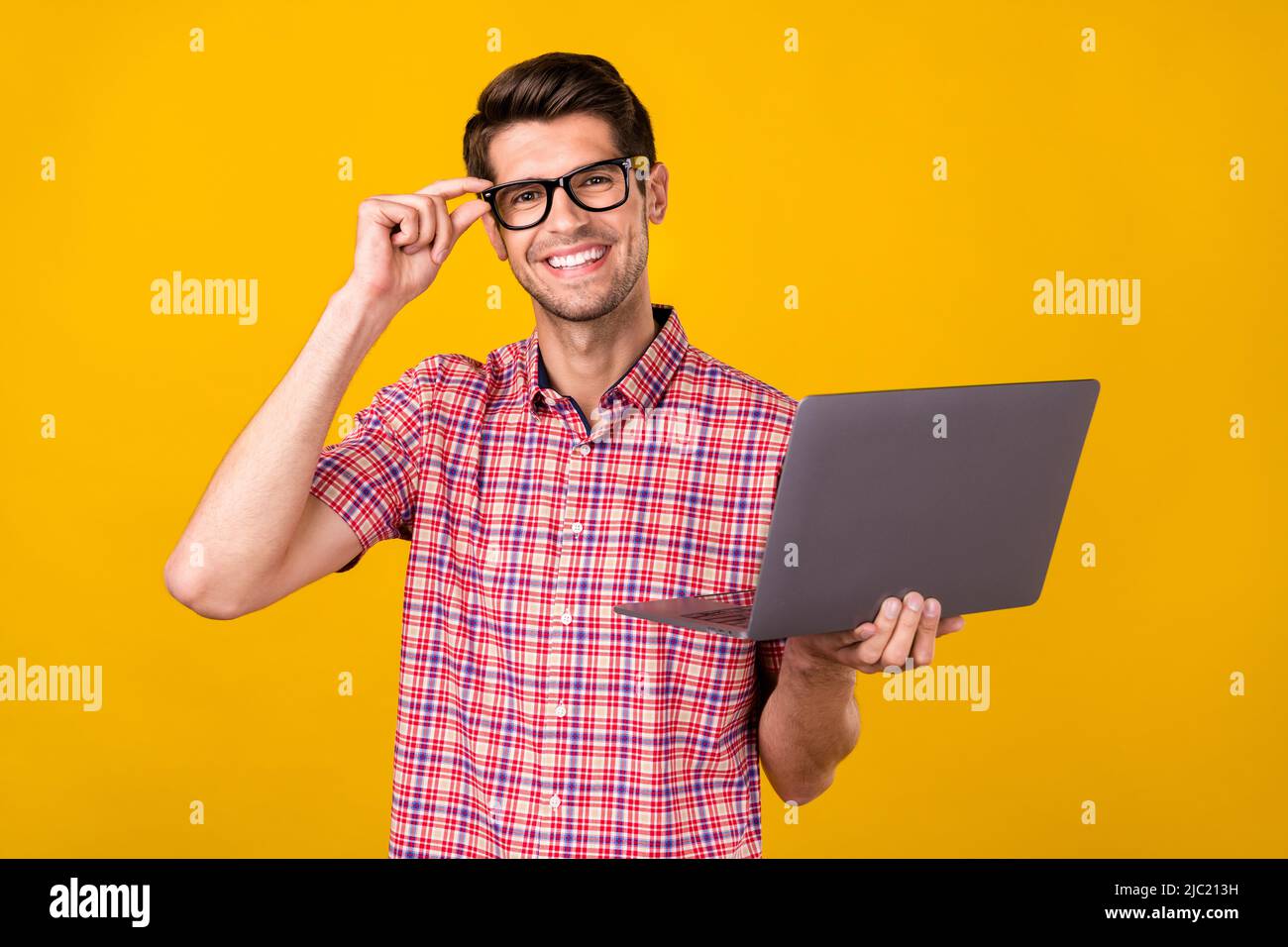 Photo of young business man happy positive smile work laptop programmer isolated over yellow ...