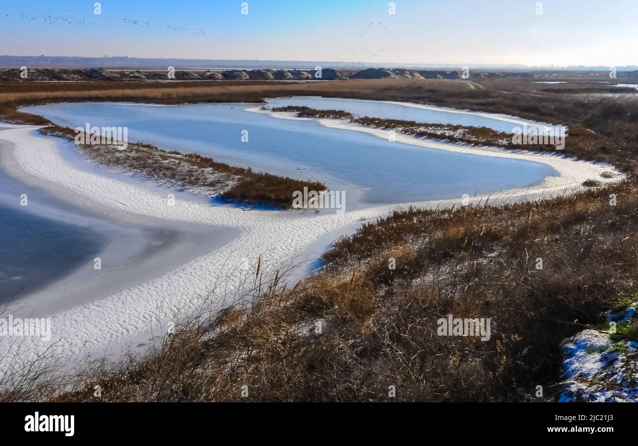 Frozen water, patterns of snow in small lakes. Tiligul estuary, Ukraine ...