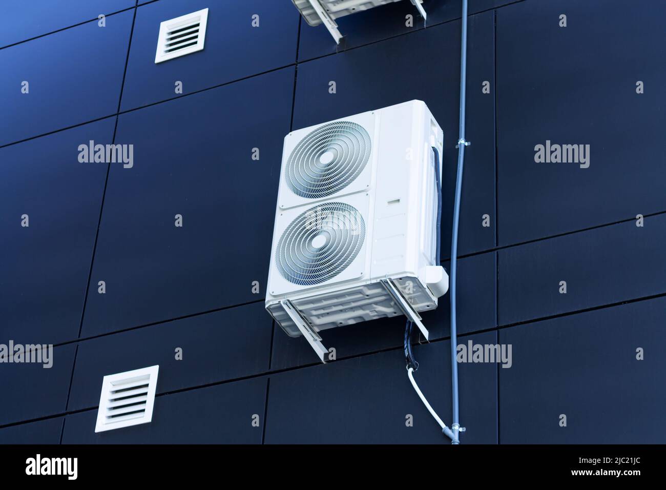 Air conditioner compressor unit install outside on house wall Stock ...