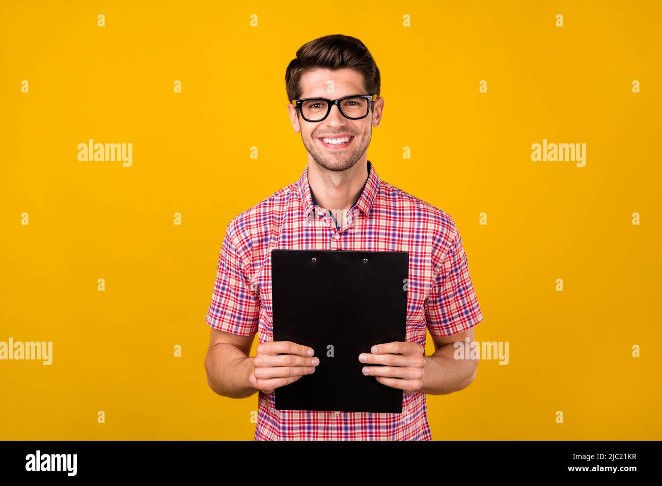 Photo of young business man happy positive smile hold clipboard ...
