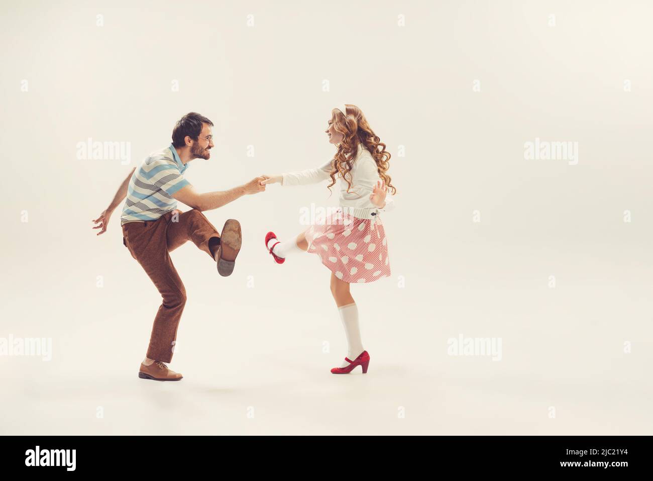 Young man and woman in vintage retro style outfits dancing social dance ...