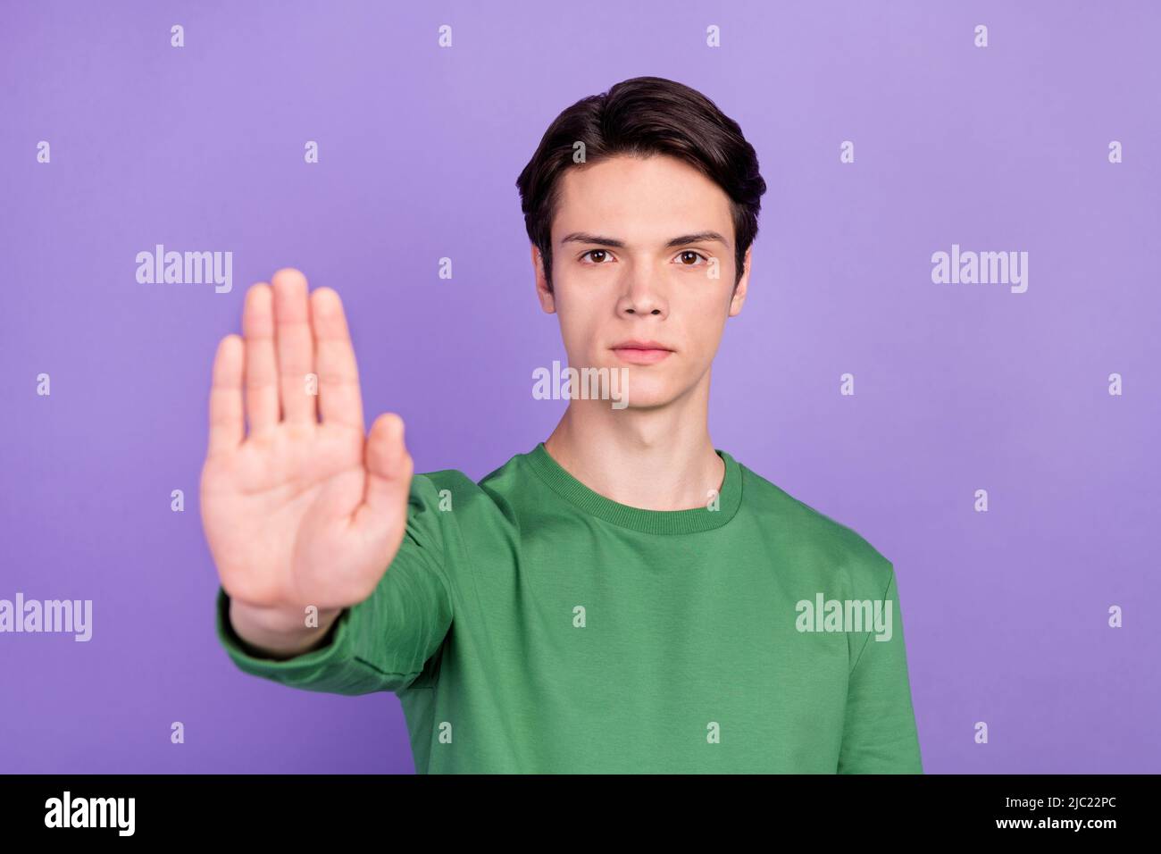 Photo of young handsome guy negative show hand no stop sign decline ban ...