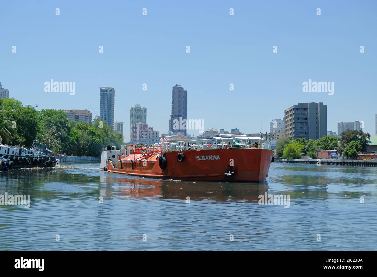 Manila, Philippines: cargo ship crossing the rehabilitated Pasig River ...