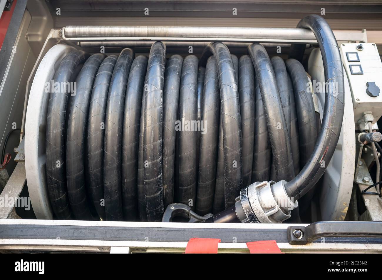 Hose needed to put out the fire is rolled up in the fire engine Stock ...