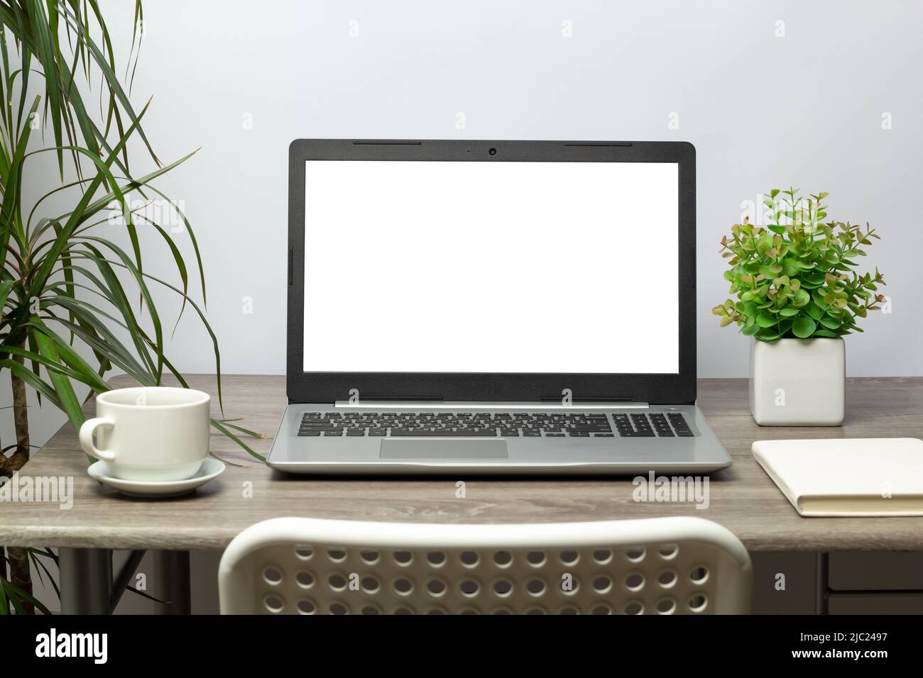 Work desk with laptop with white blank screen Stock Photo - Alamy