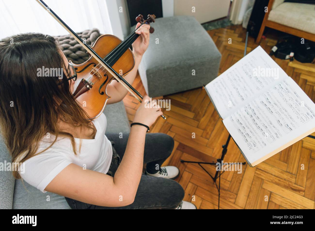 top view young caucasian woman sitting on sofa in living room at home ...