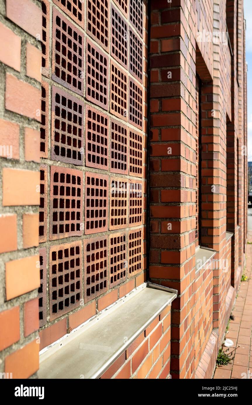 Windows immured with bricks with holes for ventilation, in a multi ...