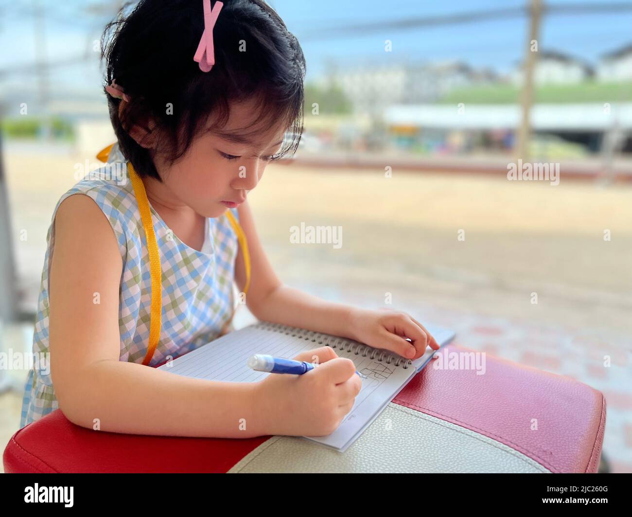 cute little girl writes on her notebook Stock Photo - Alamy