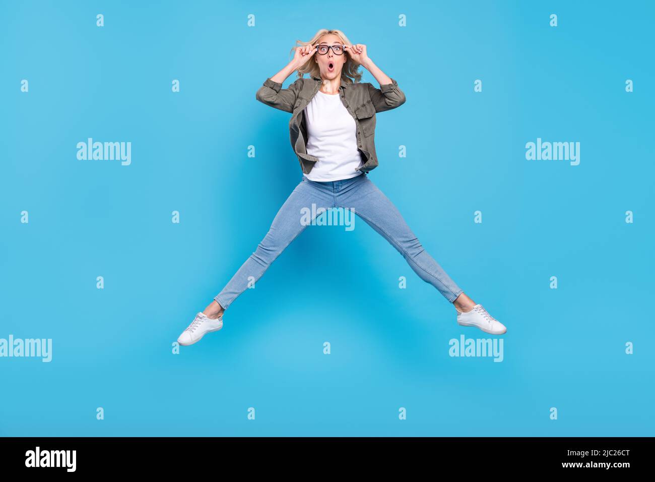 Full length body size photo amazed woman in glasses jumping up amazed ...