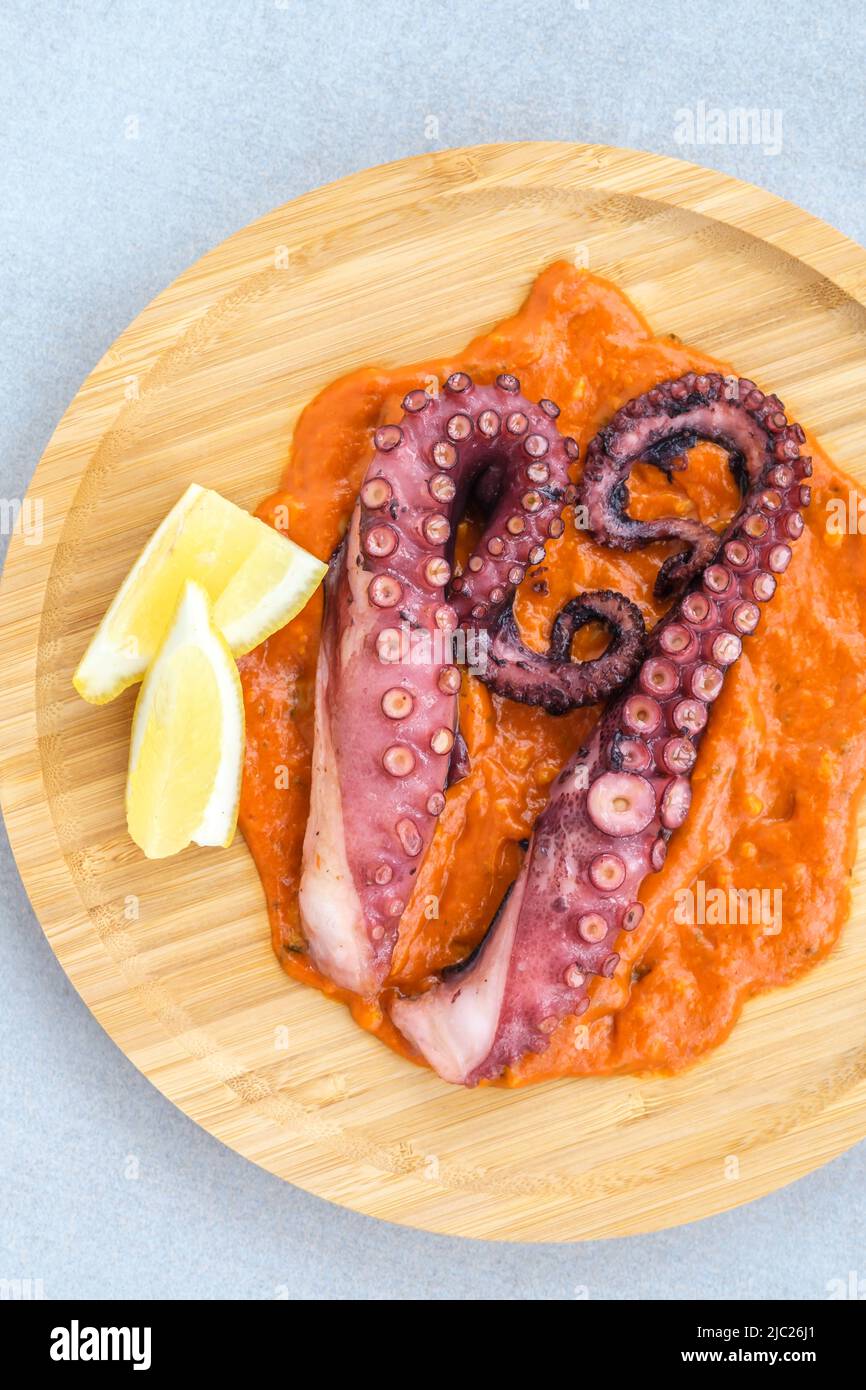 Roasted octopus tentacles with chilli romesco sauce Stock Photo - Alamy
