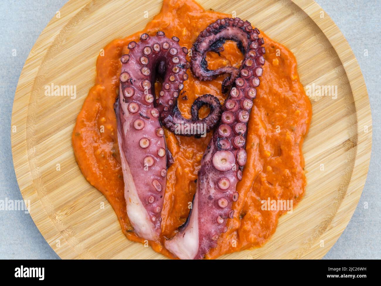 Roasted octopus tentacles with chilli romesco sauce Stock Photo - Alamy