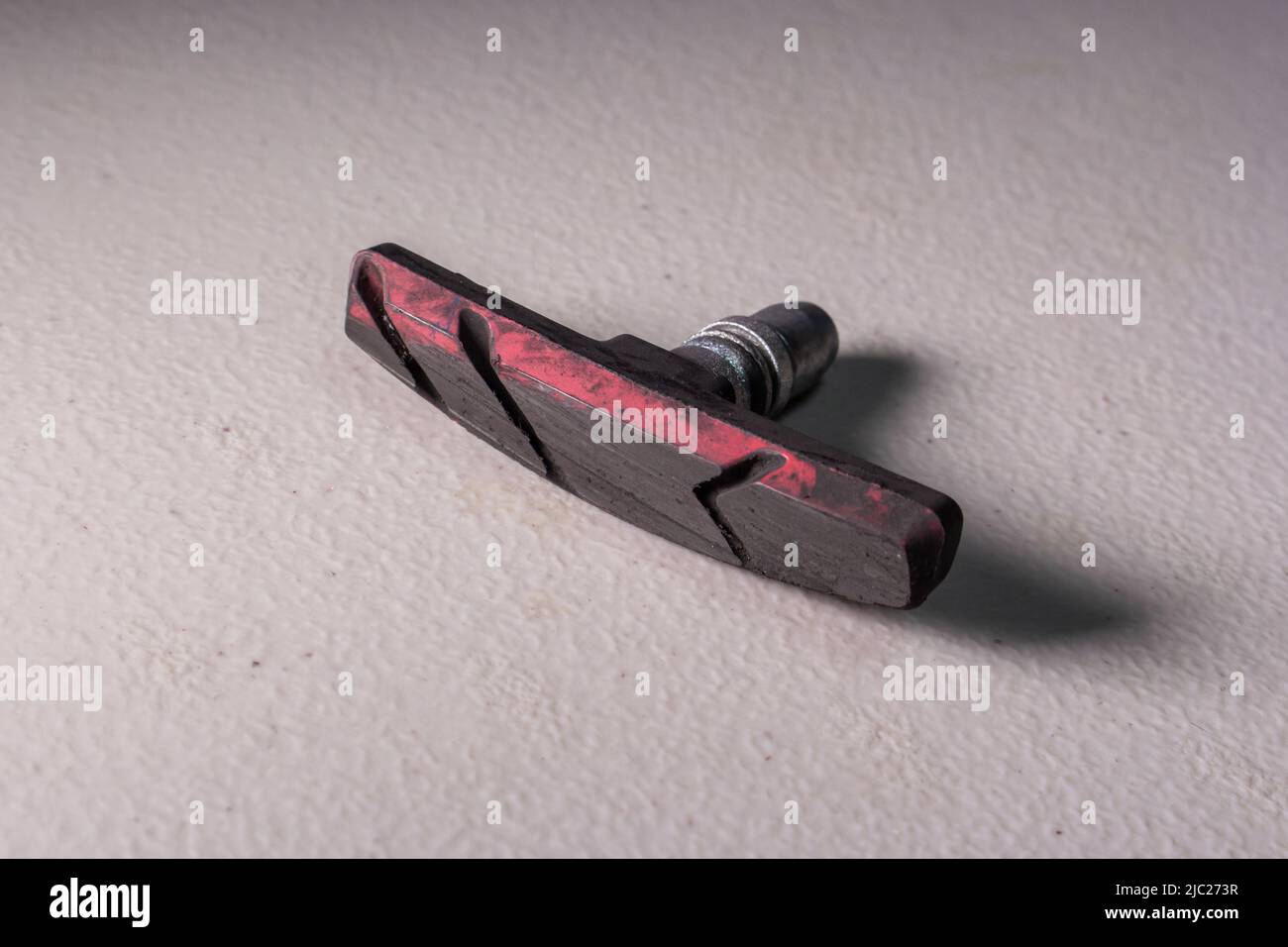 An old brake shoe for bicycle on a table. A brake in an image is ...