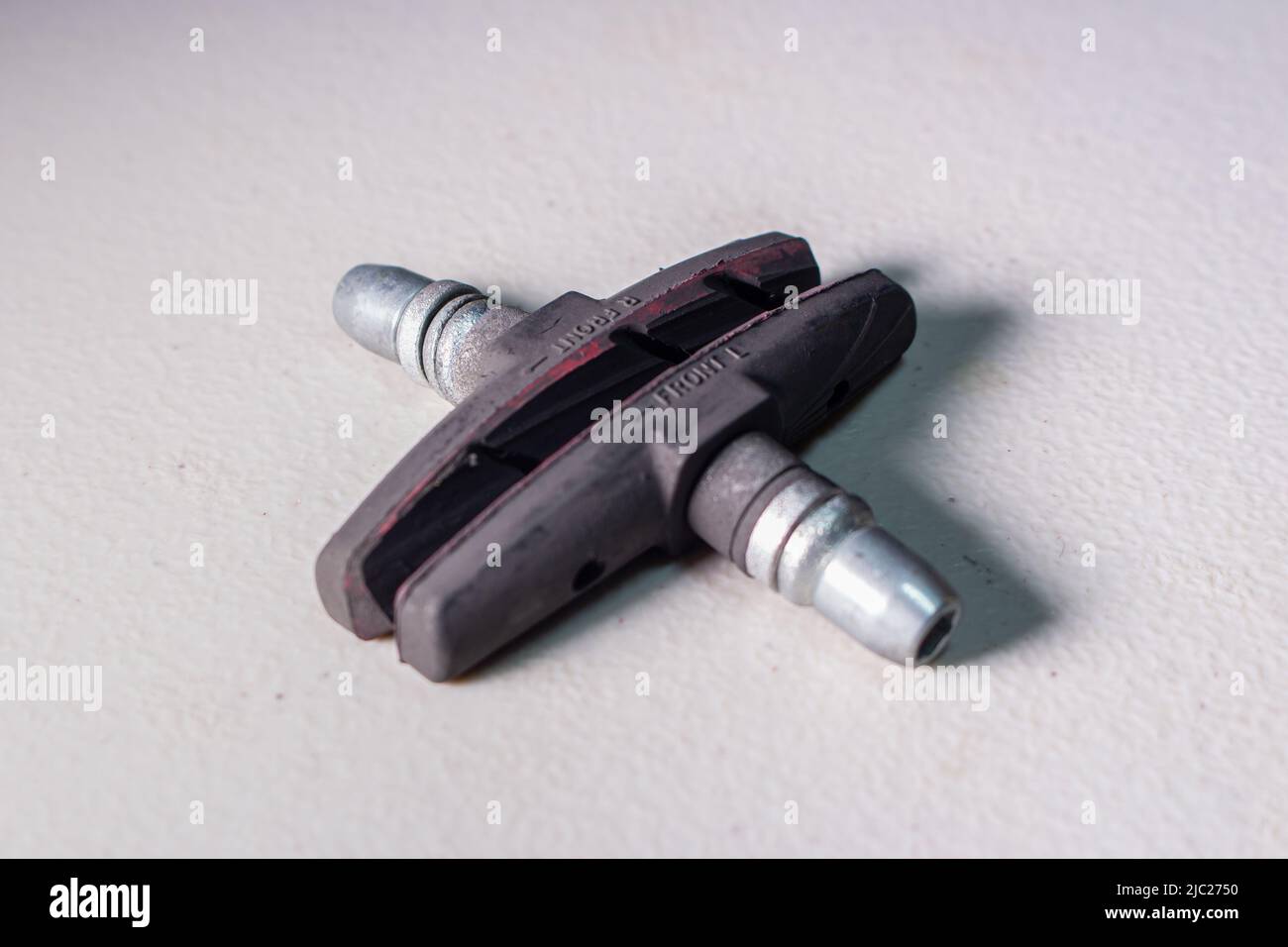 Old brake shoes for bicycle on a table. Brake shoes in an image are ...