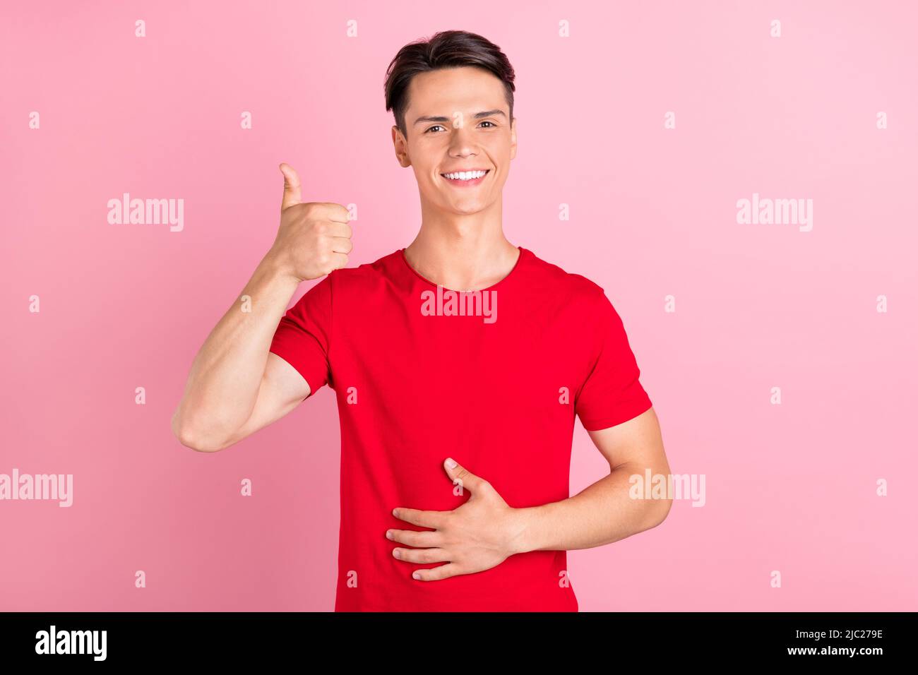Photo of charming pretty young man wear red t-shirt smiling showing ...
