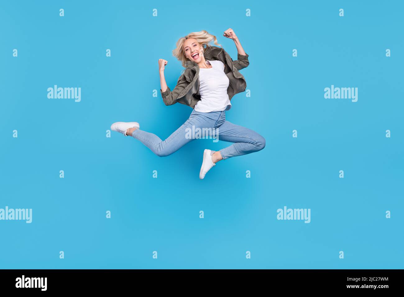 Full length body size photo woman jumping up showing strong hands ...