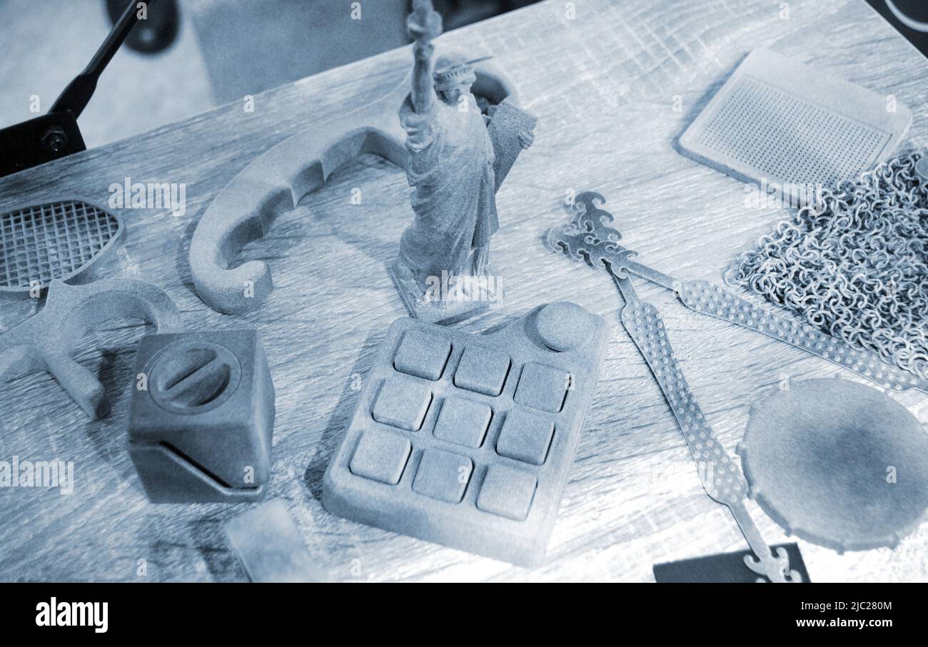 Many different models printed on 3D printer. Gray and black objects ...