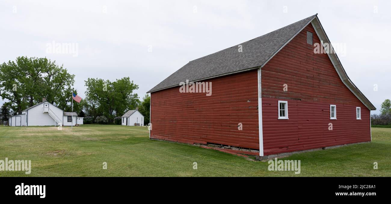A red barn with the main house and summer kitchen at the Welk Homestead ...