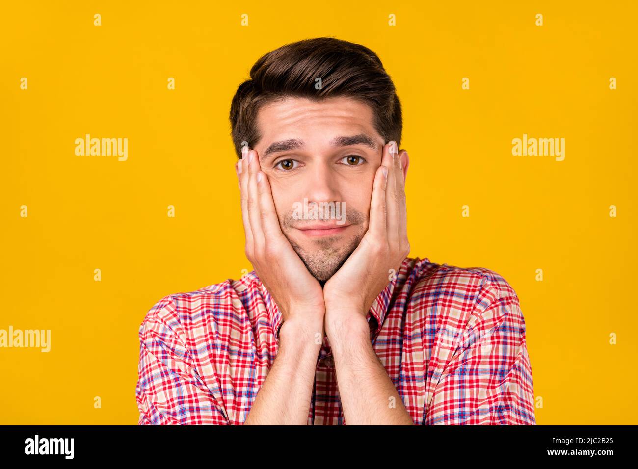 Photo of happy positive young man hold hands face cheeks smile good ...