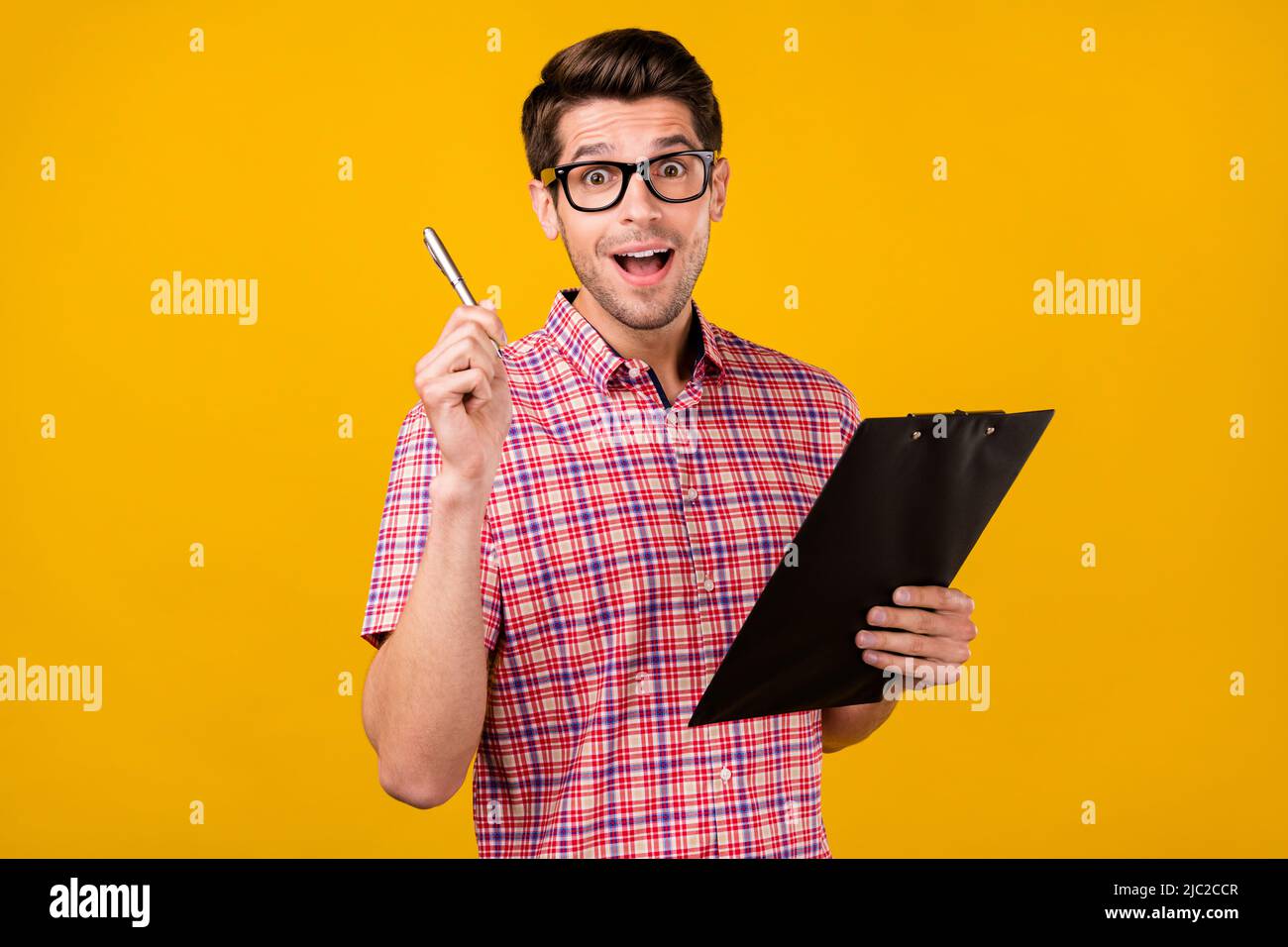 Portrait of attractive cheerful guy geek writing list idea creative ...