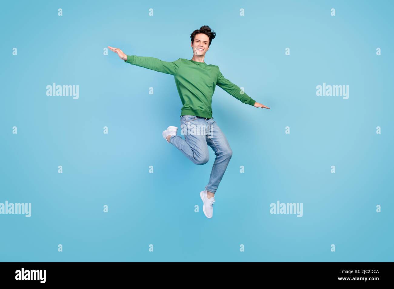 Full length body size photo guy jumping high careless playful smiling ...