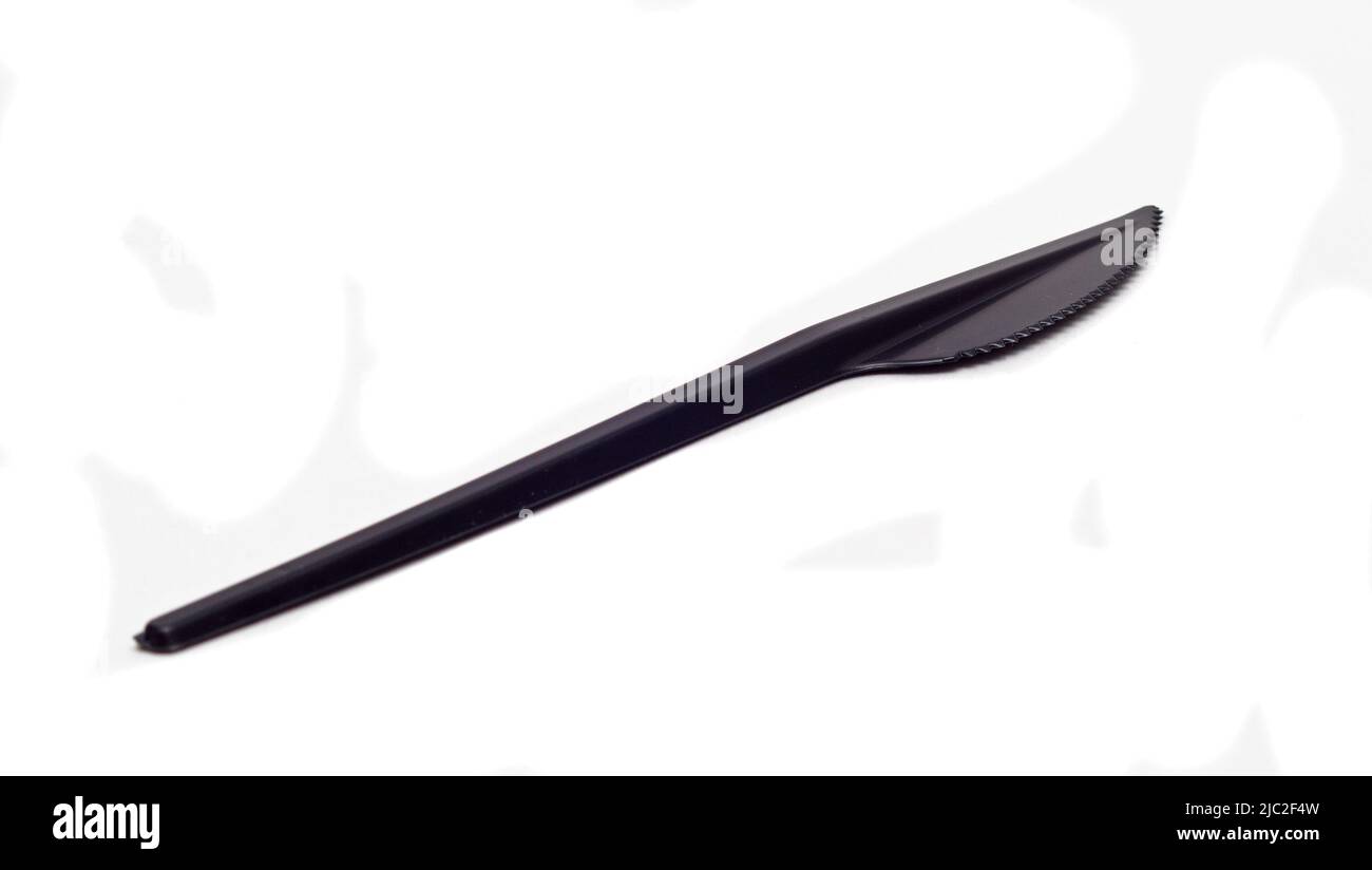 black plastic table knife on white background isolated closeup ...
