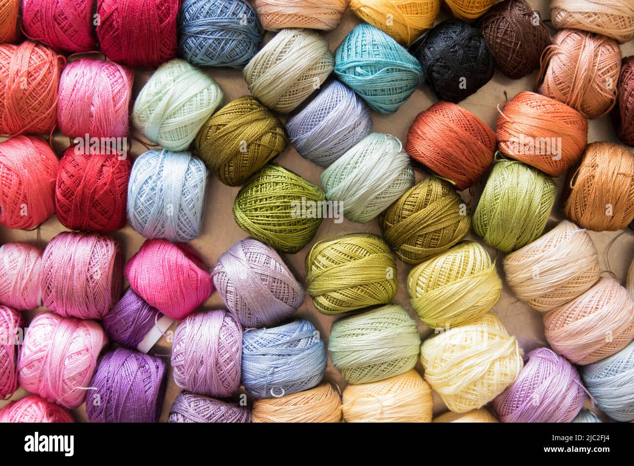 Close up photo of many colorful embroidery thread rolls made of cotton ...
