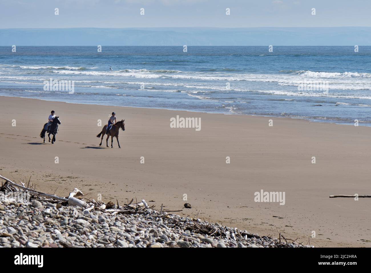 Horses being ridden on beach hi-res stock photography and images - Alamy