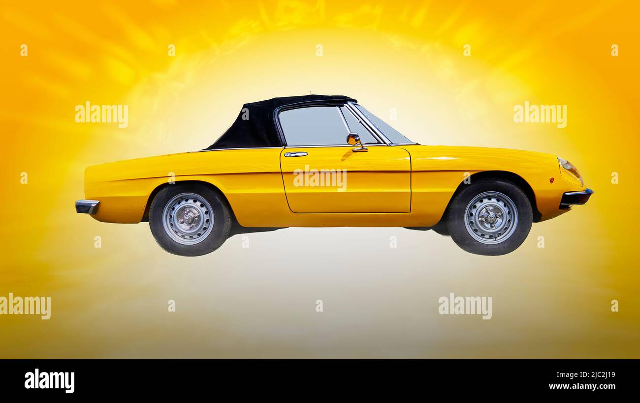 Alfa Romeo Spider convertible in screaming yellow against sunny ...